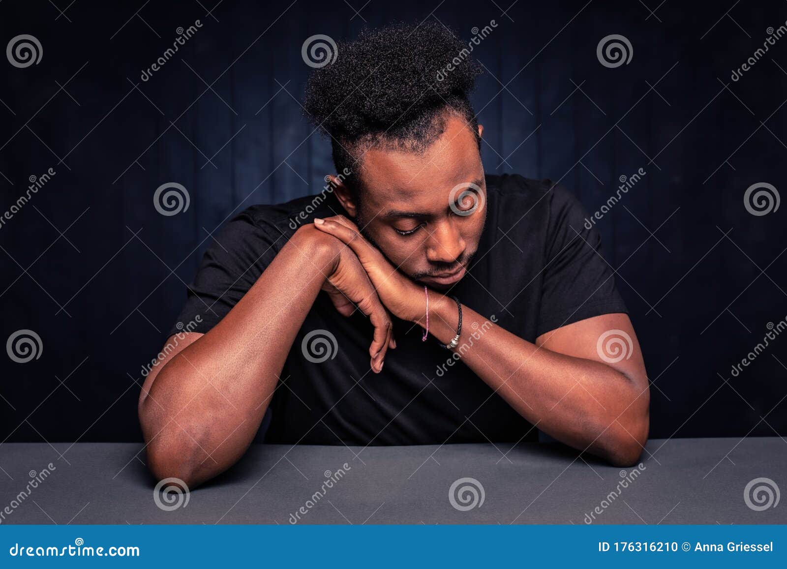 Handsome Black Man Looking Down Stock Photo - Image of seated ...
