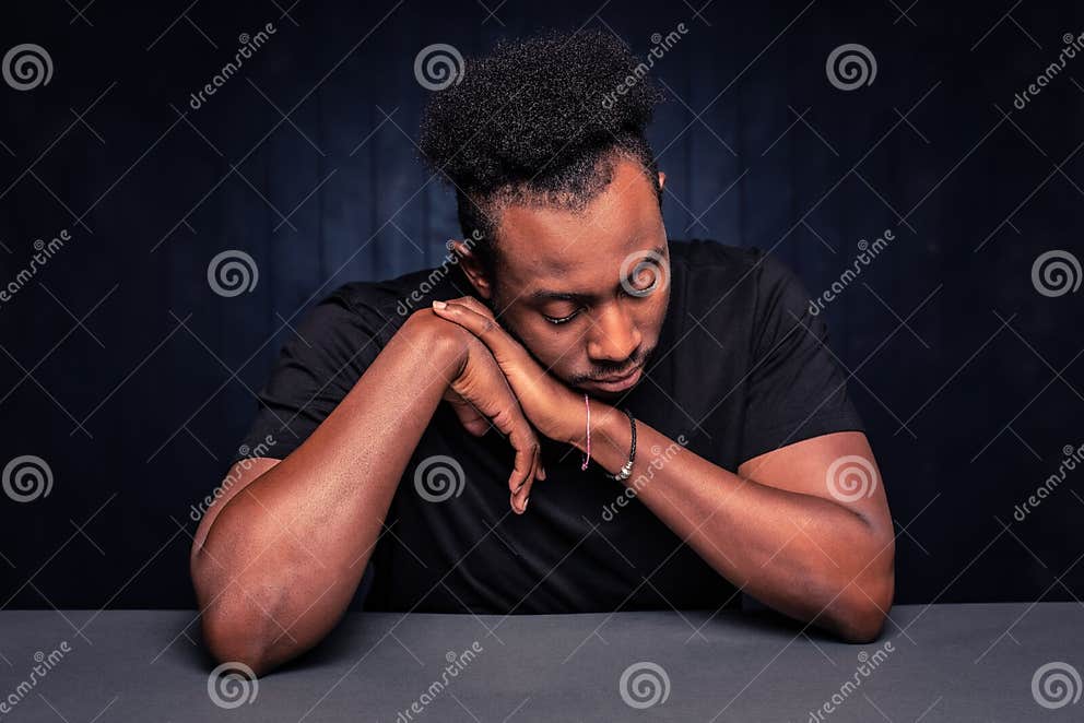 Handsome Black Man Looking Down Stock Photo - Image of seated ...