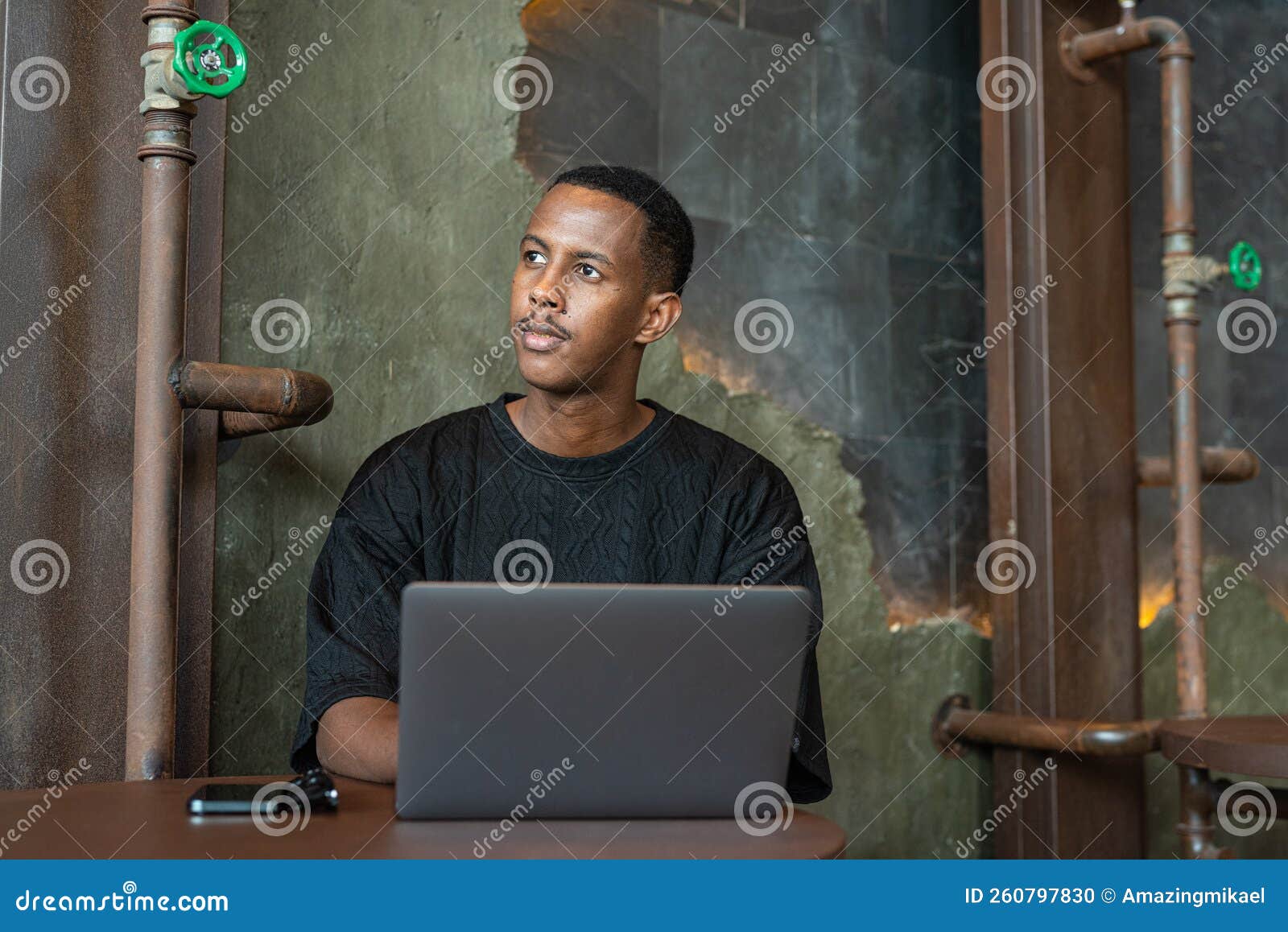Handsome Black Man Sitting and Using Laptop Computer Indoors Stock ...