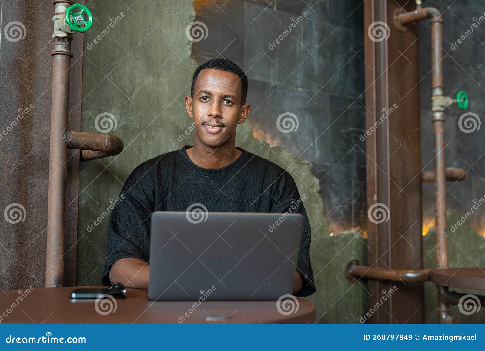 Handsome Black Man Sitting and Using Laptop Computer Indoors Stock ...