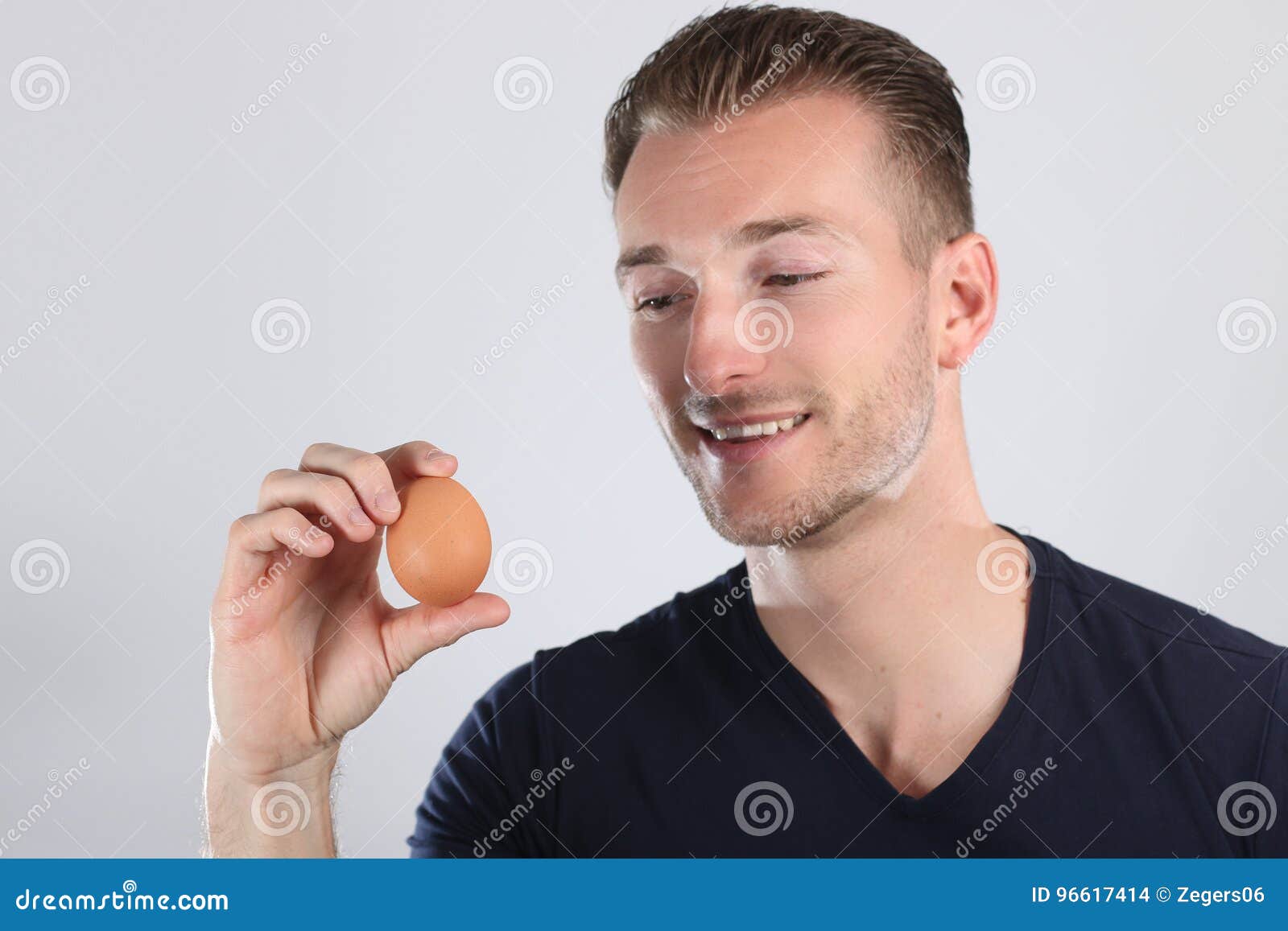 Handsome Blond Man on Smiling Face Looking Egg in Studio Stock Photo ...