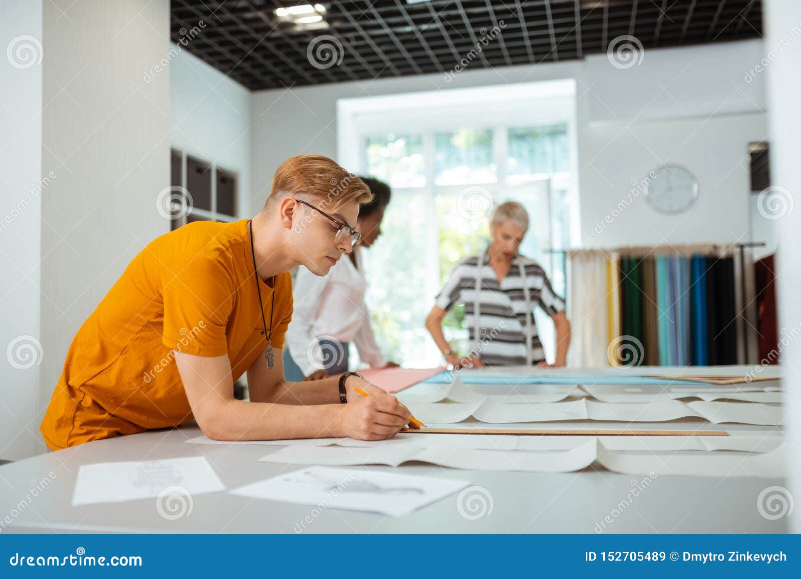 Handsome Blond Young Man Drafting a Sewing Pattern Stock Image - Image ...