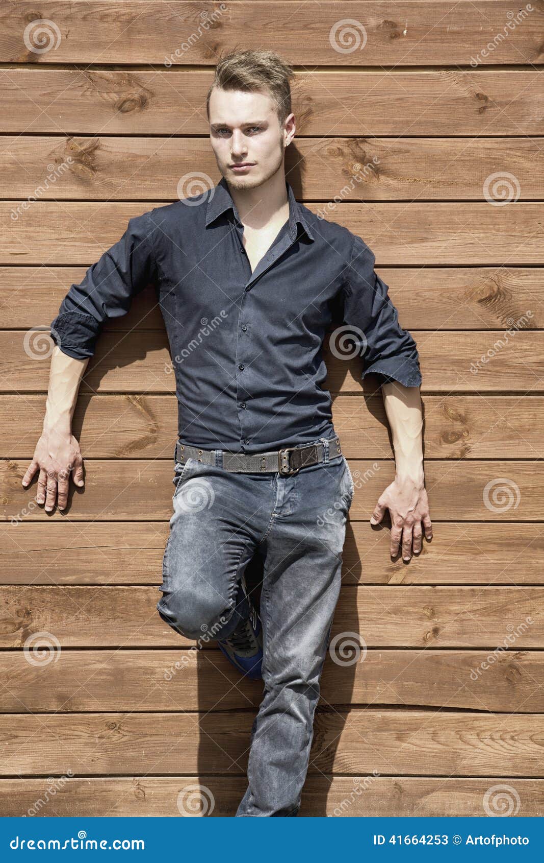 Handsome Blond Young Man Standing Outside Against Wood Wall Stock Image ...