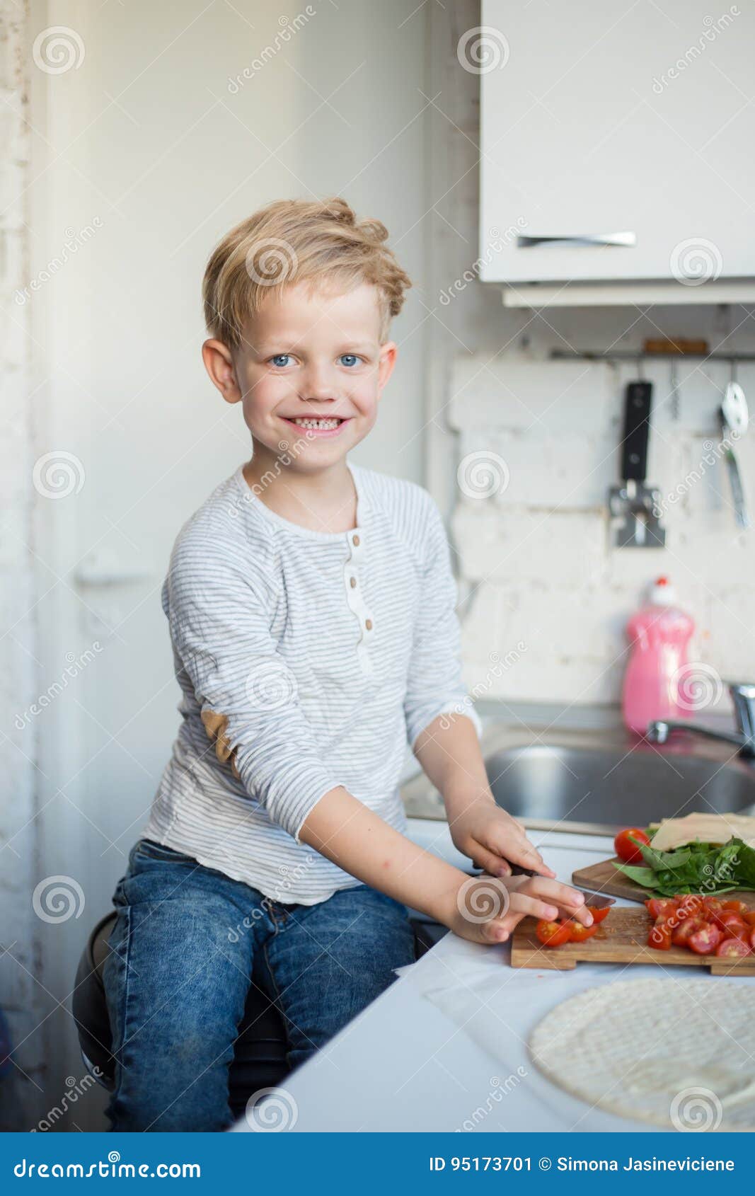 Handsome Boy is Cooking in the Kitchen at Home. Healthy Food Stock ...