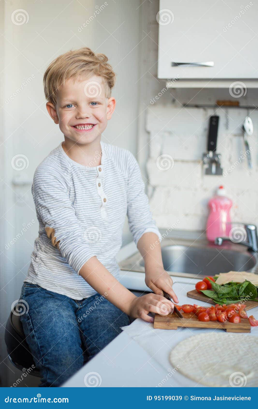 Handsome Boy is Cooking in the Kitchen at Home. Healthy Food Stock ...