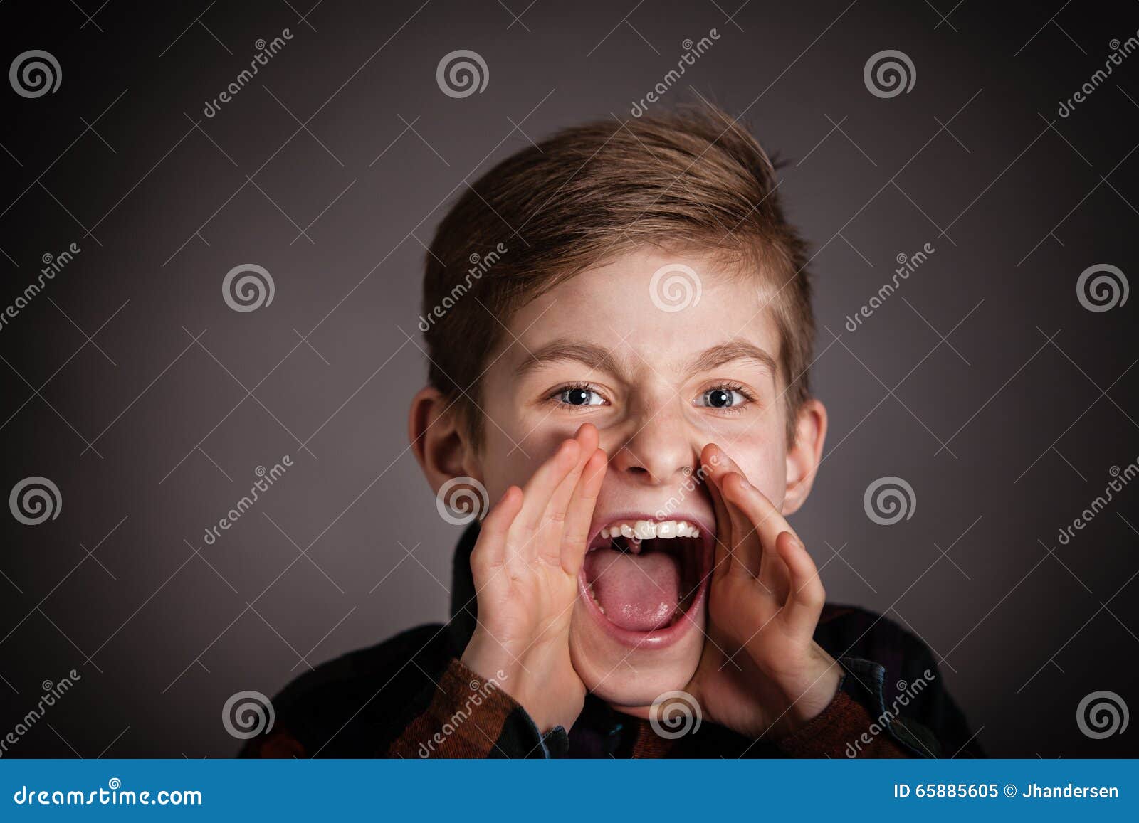 Handsome Boy Screaming at the Camera Against Gray Stock Image - Image ...