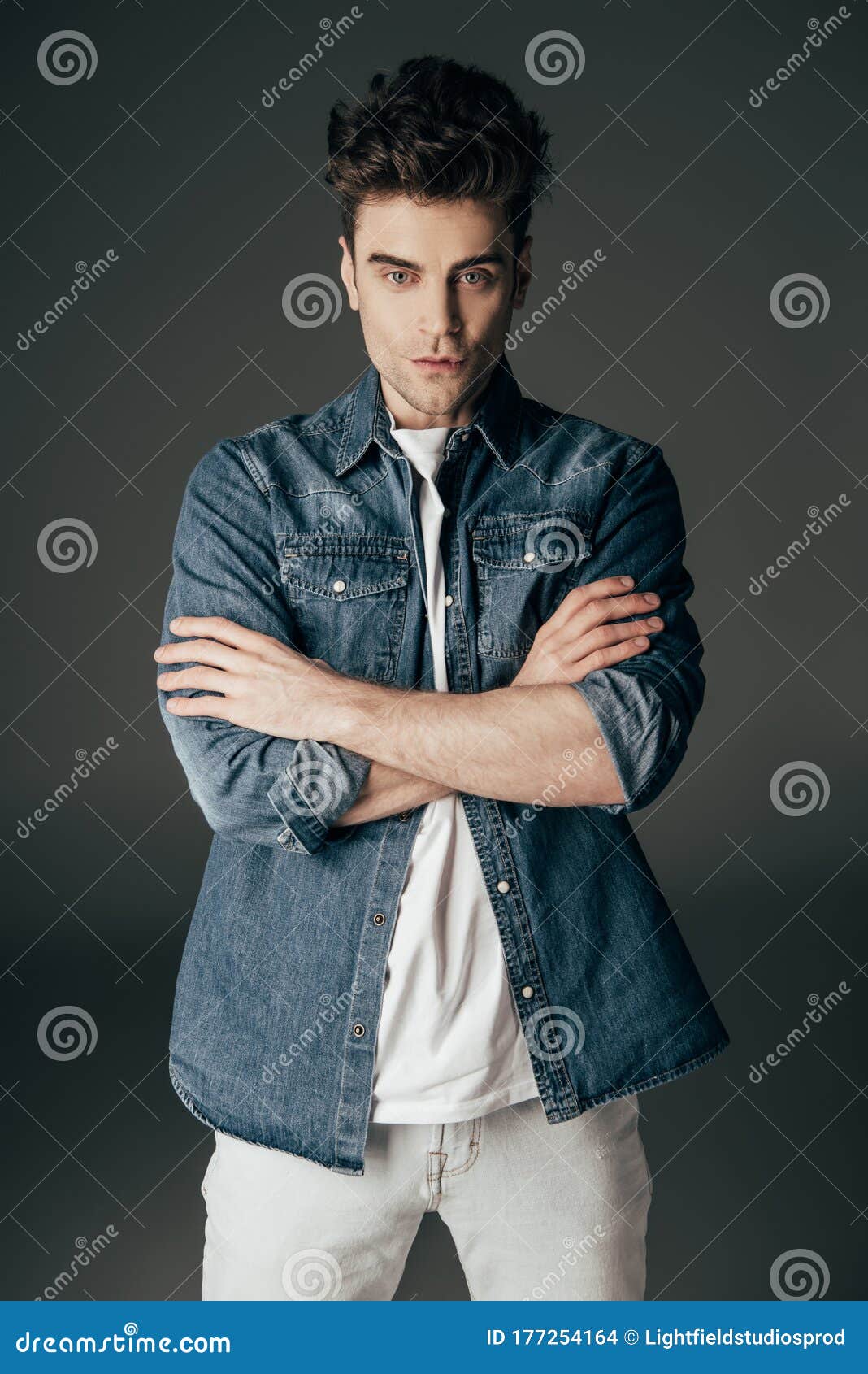 Handsome And Brunette Man With Crossed Arms Looking At Camera Stock
