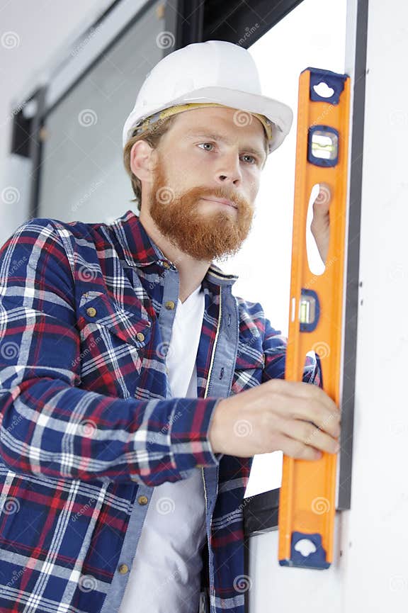 Handsome Builder Measuring Wall with Level Tool Stock Photo - Image of ...