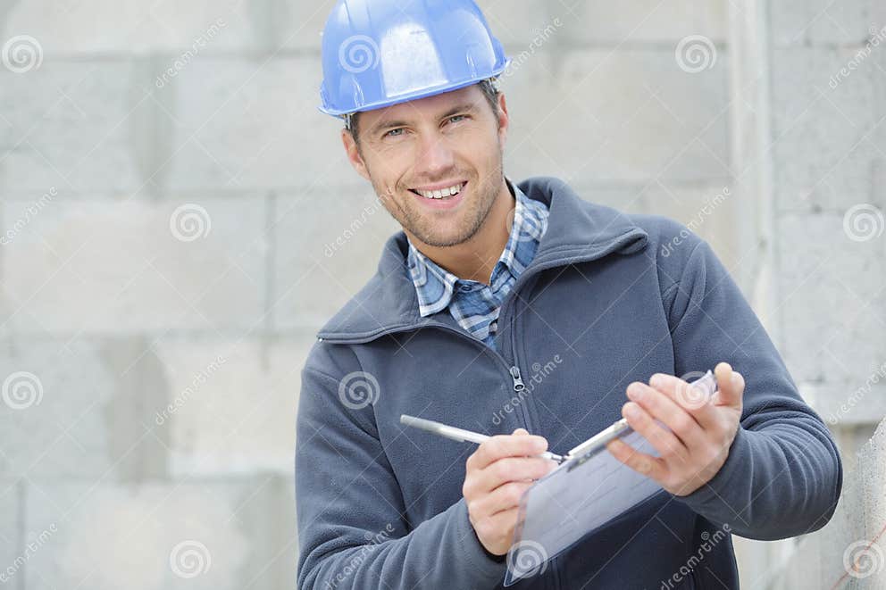 Handsome Builder Writing Something in Clipboard Stock Image - Image of ...