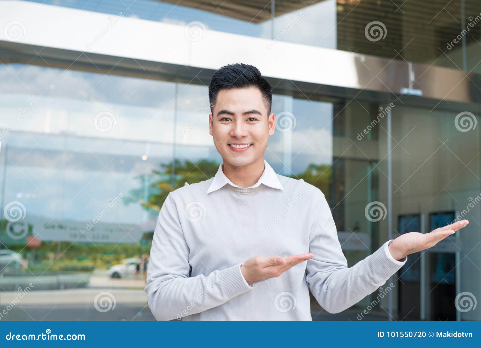 Handsome Businessman with Arm Out in a Welcoming Gesture Stock Photo ...