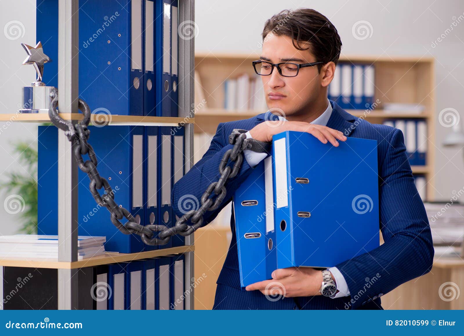 The Handsome Businessman Chained To the Office Shelf Stock Image ...