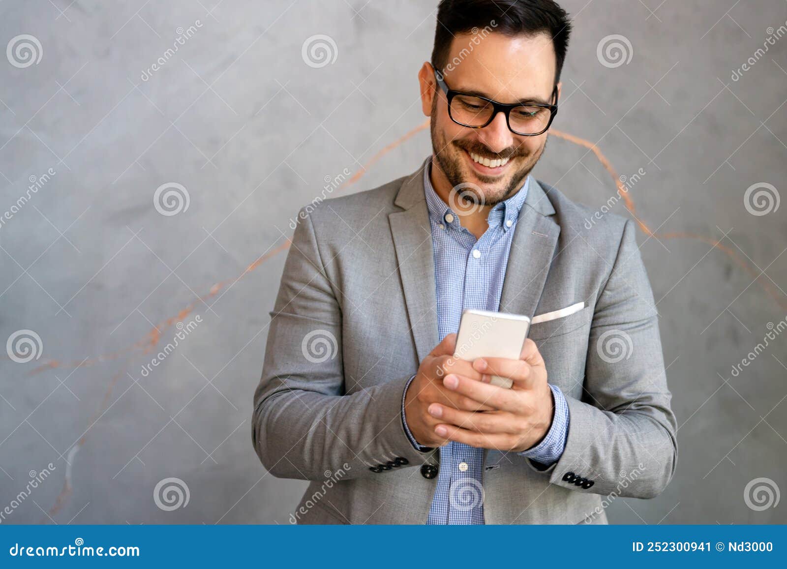 Handsome Businessman Checking Emails on the Phone in Modern Office in ...