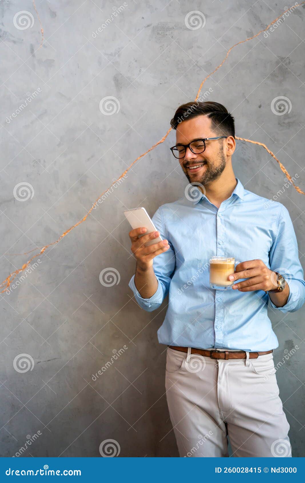Handsome Businessman Checking Emails on the Phone in Modern Office in ...