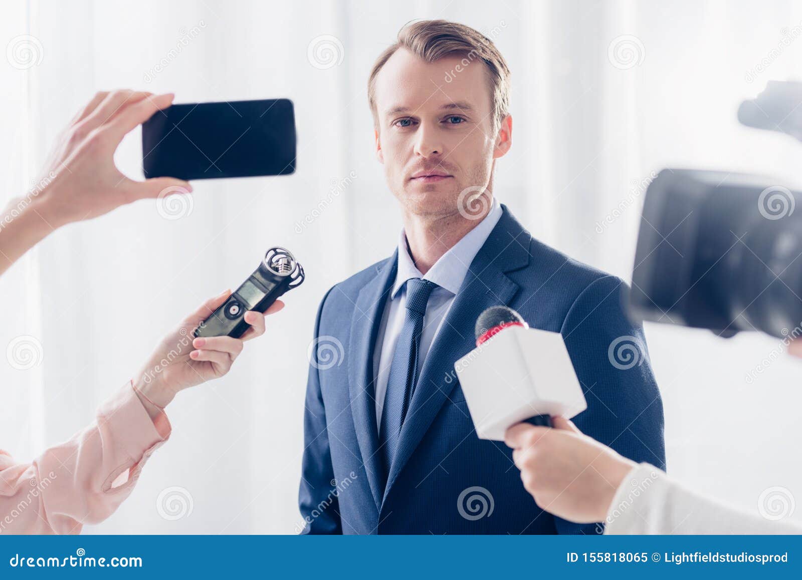 Handsome Businessman Giving Interview To Journalists and Looking at ...
