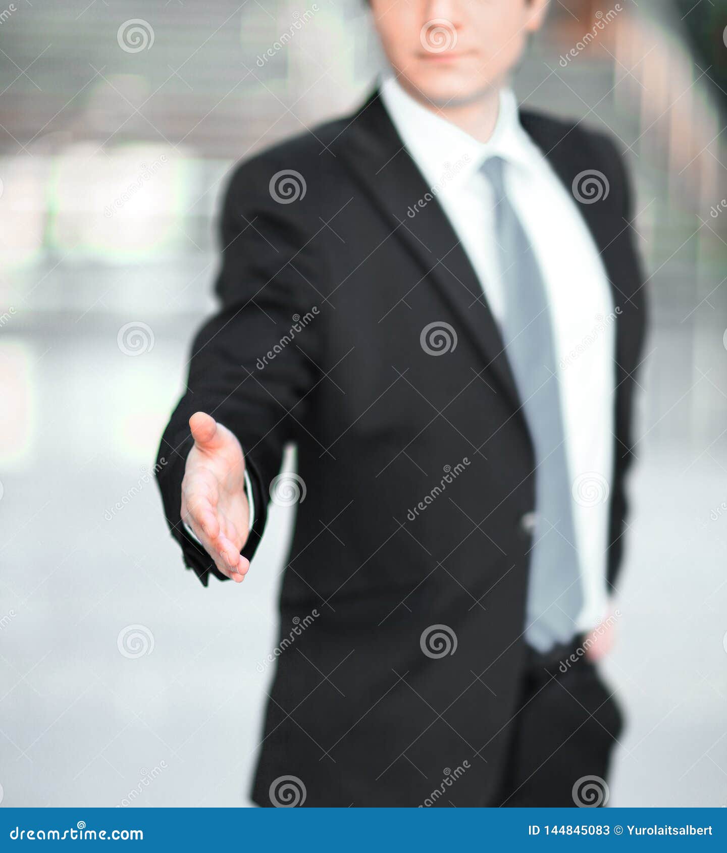 Handsome Businessman Holding Out Hand For A Handshake Stock Image
