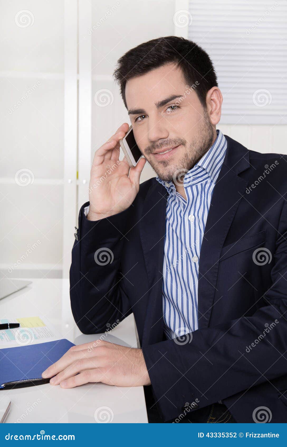 Handsome Businessman Sitting at Desk Talking on Mobile. Stock Photo ...