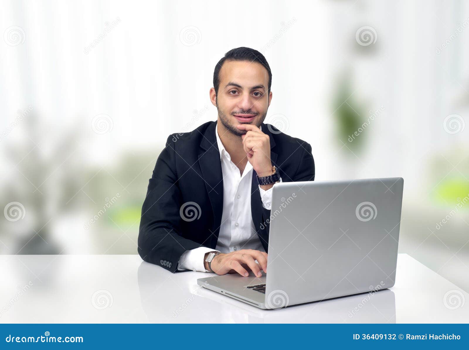 Handsome Businessman Sitting in a Modern Office Stock Photo - Image of ...