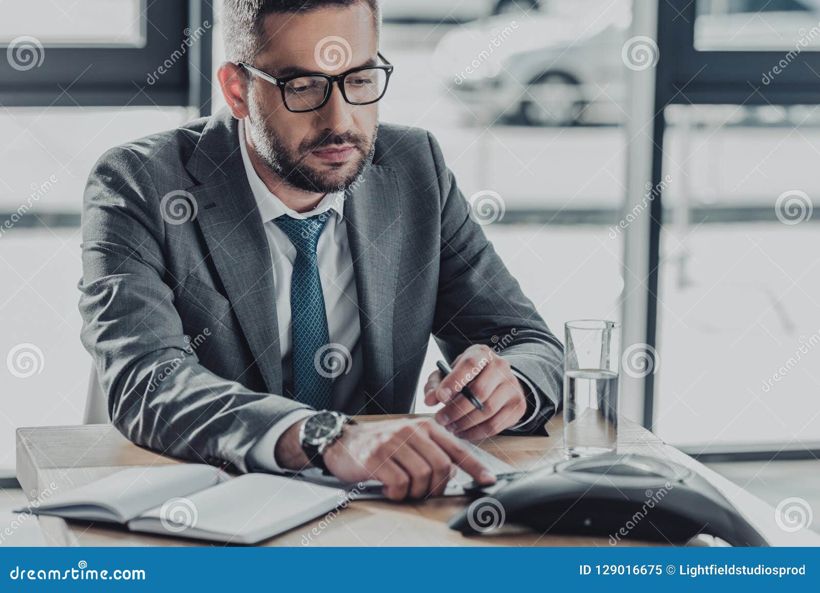 Handsome Businessman Using Conference Phone on Table Stock Image ...