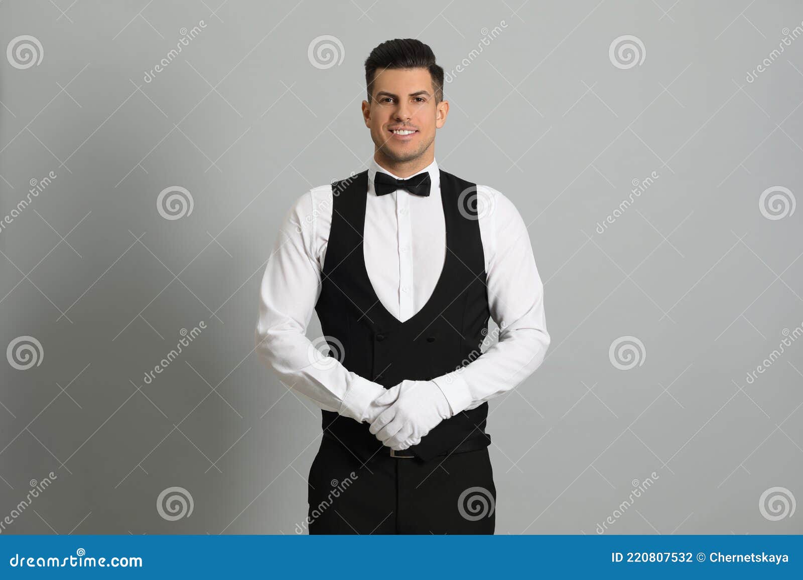 Handsome Butler in Elegant Uniform on Grey Background Stock Photo ...