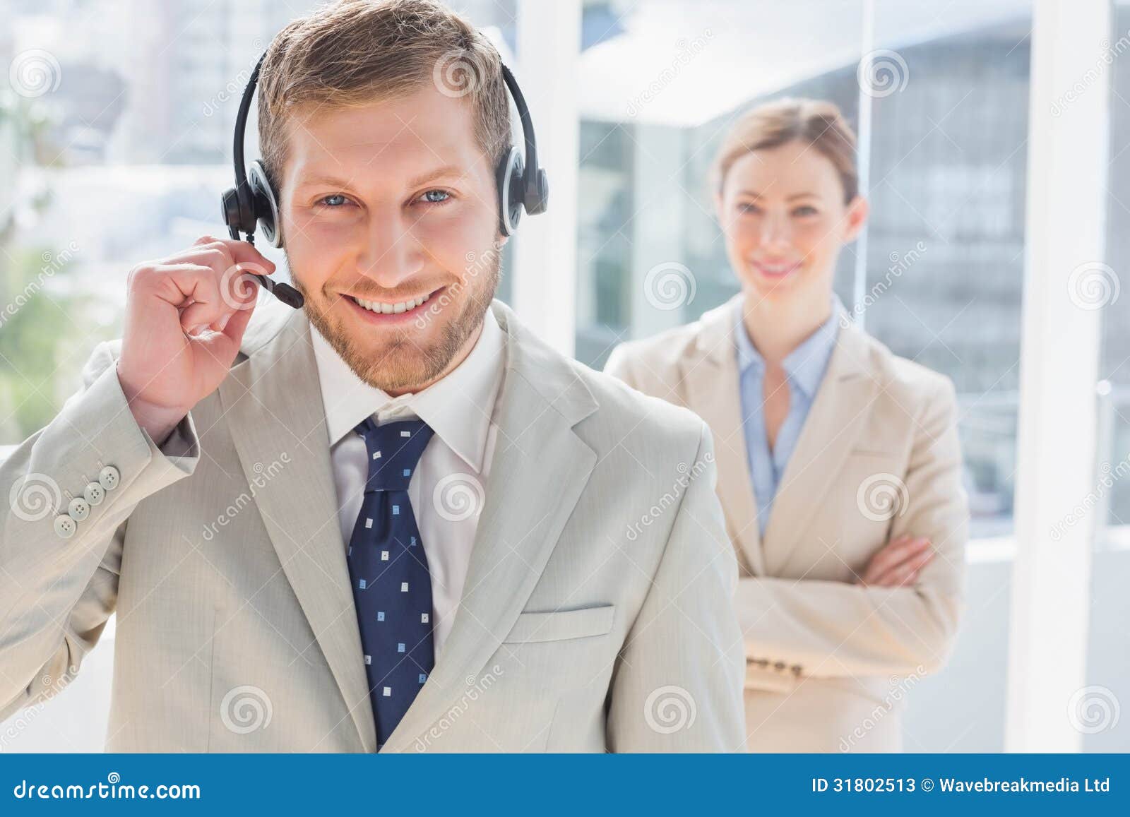 Handsome Call Centre Agent with Colleague Behind Him Stock Image ...
