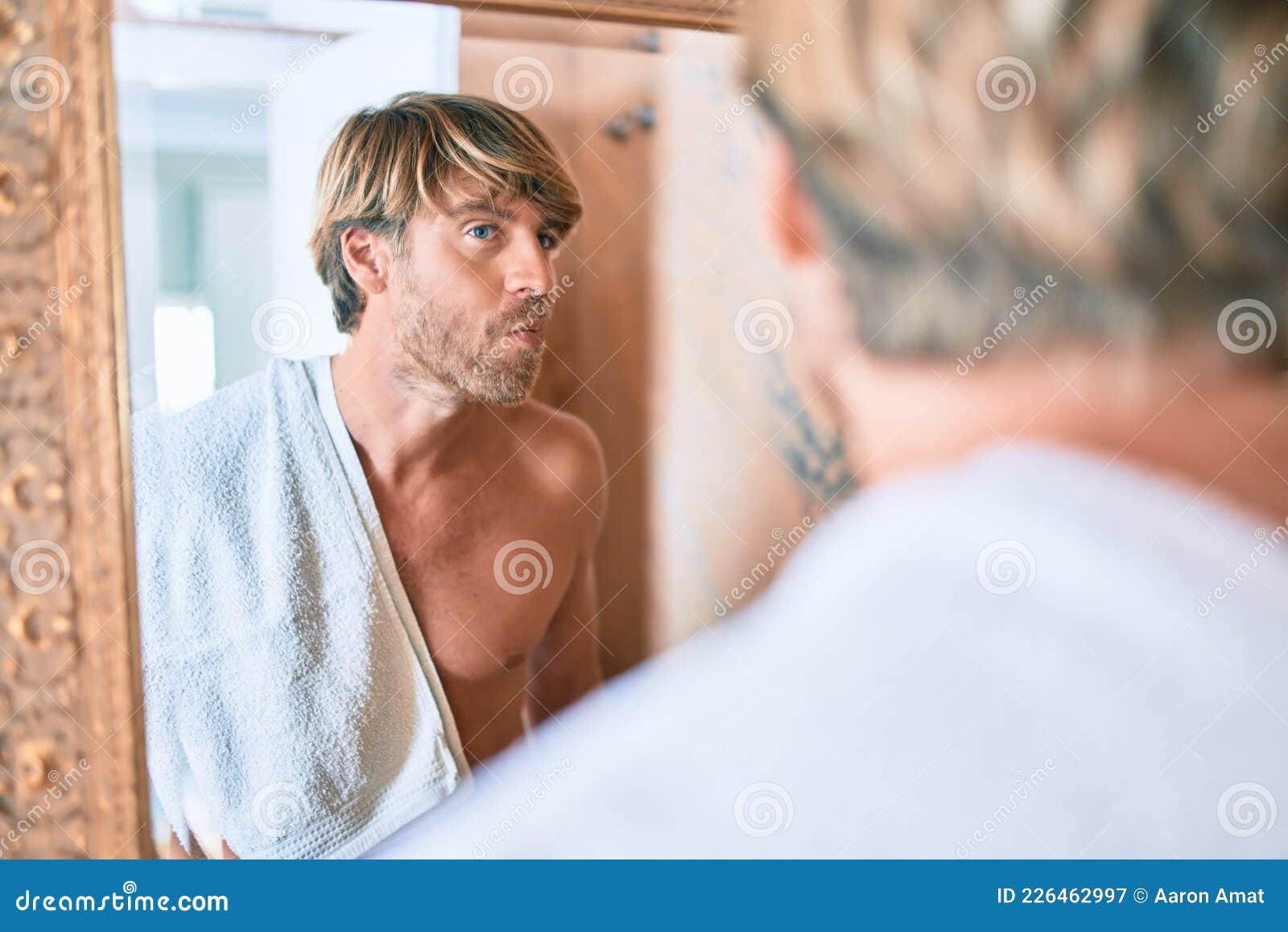 Handsome Caucasian Man Looking at Himself at the Mirror Bathroom Stock ...
