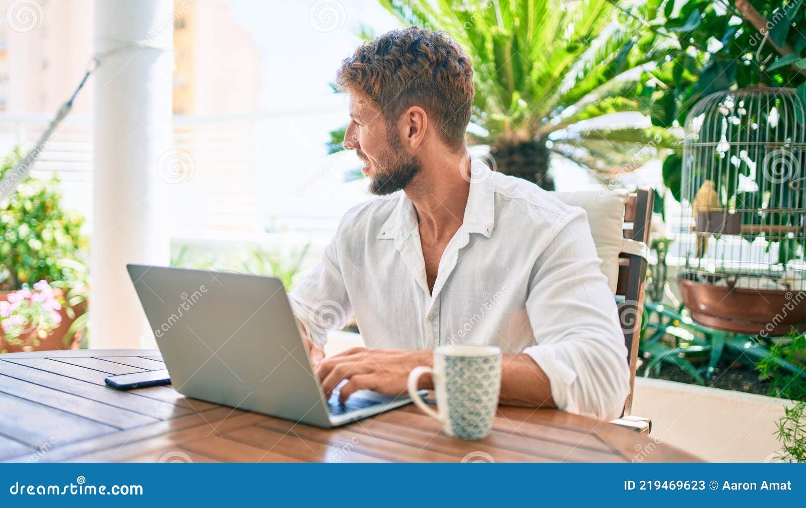 Handsome Caucasian Man Sitting on the Terrace Working from Home Using ...