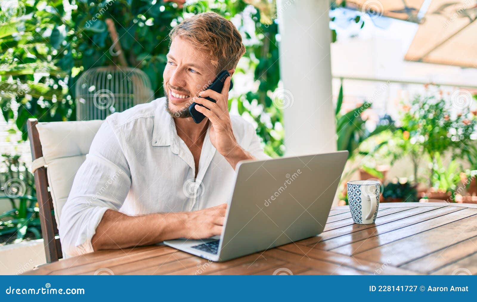 Handsome Caucasian Man Sitting on the Terrace Working from Home Using ...
