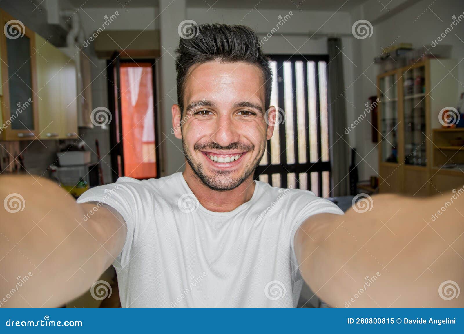 Handsome Caucasian Man Taking A Selfie Portrait Indoor At Home Happy