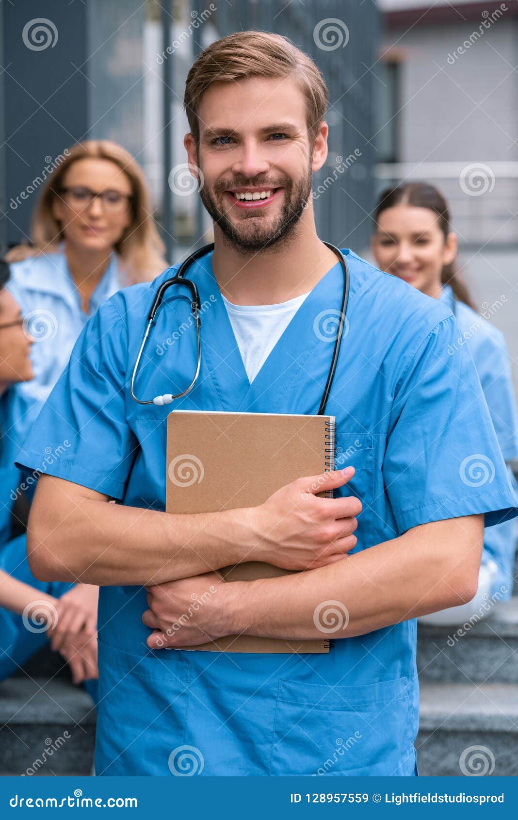Handsome Caucasian Medical Student Standing with Notebook and Looking ...