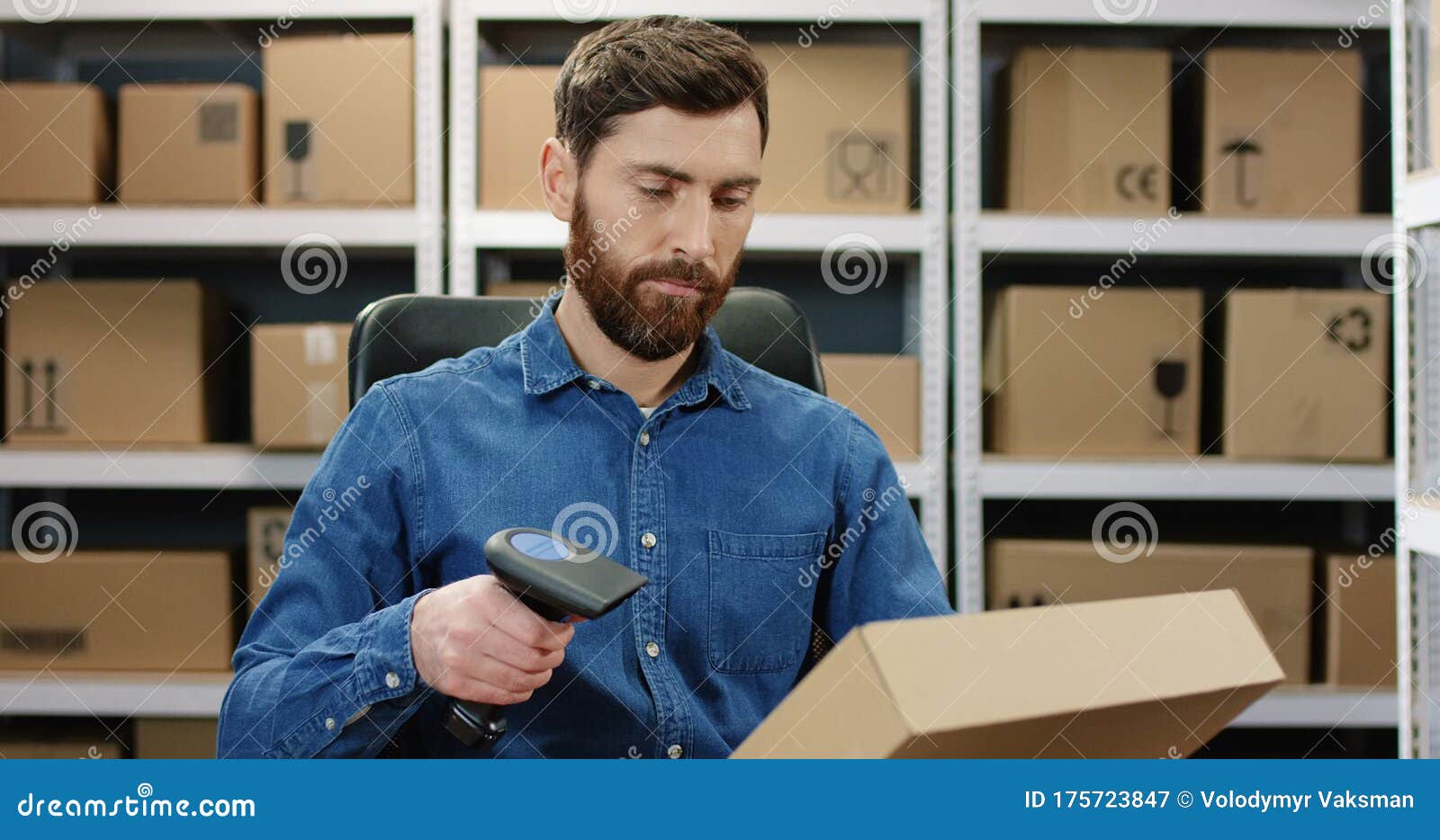 Handsome Caucasian Postman Sitting at Desk and Working at Computer in ...