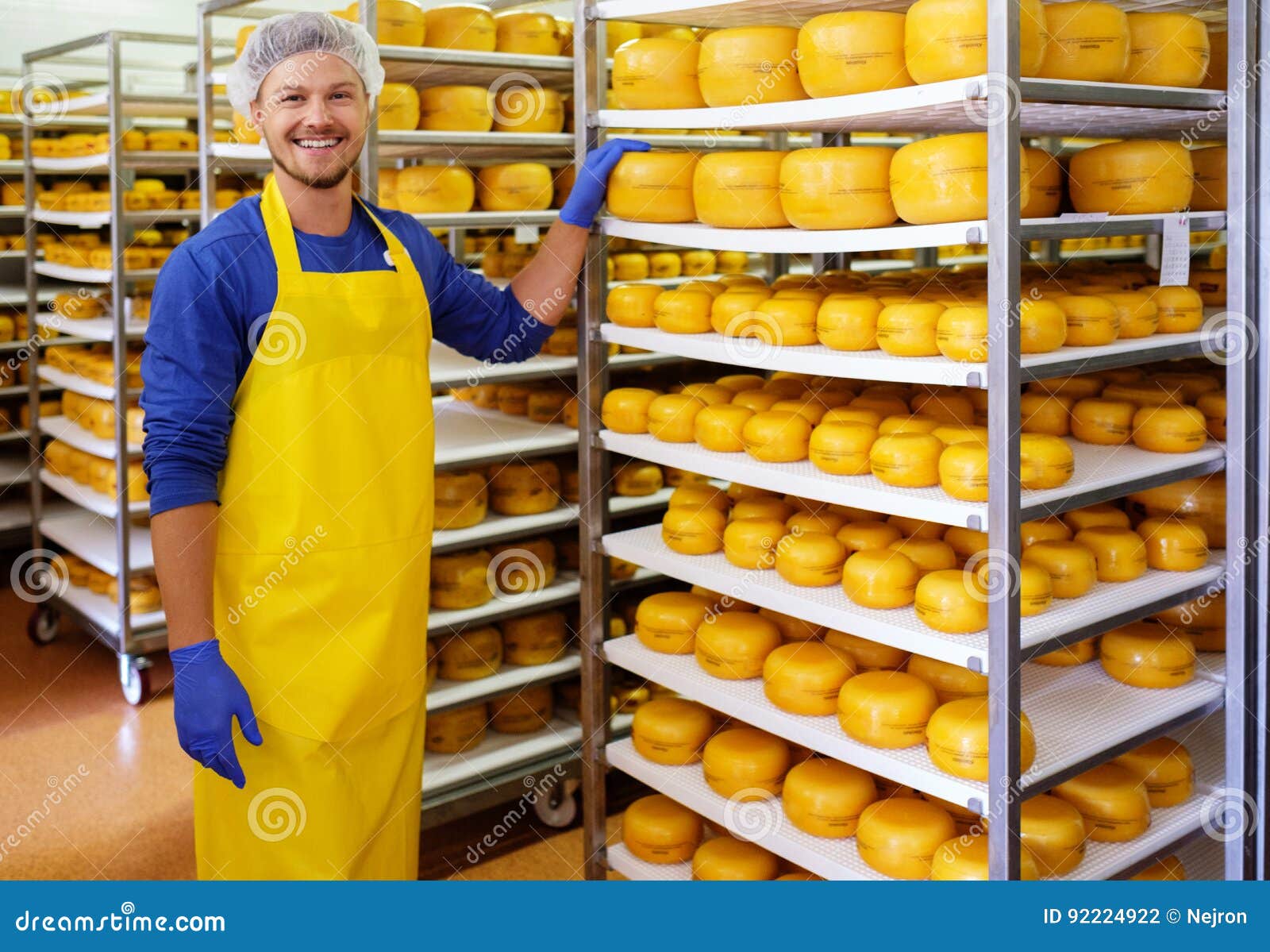 Handsome Cheesemaker is Checking Cheeses in His Workshop Storage. Stock ...