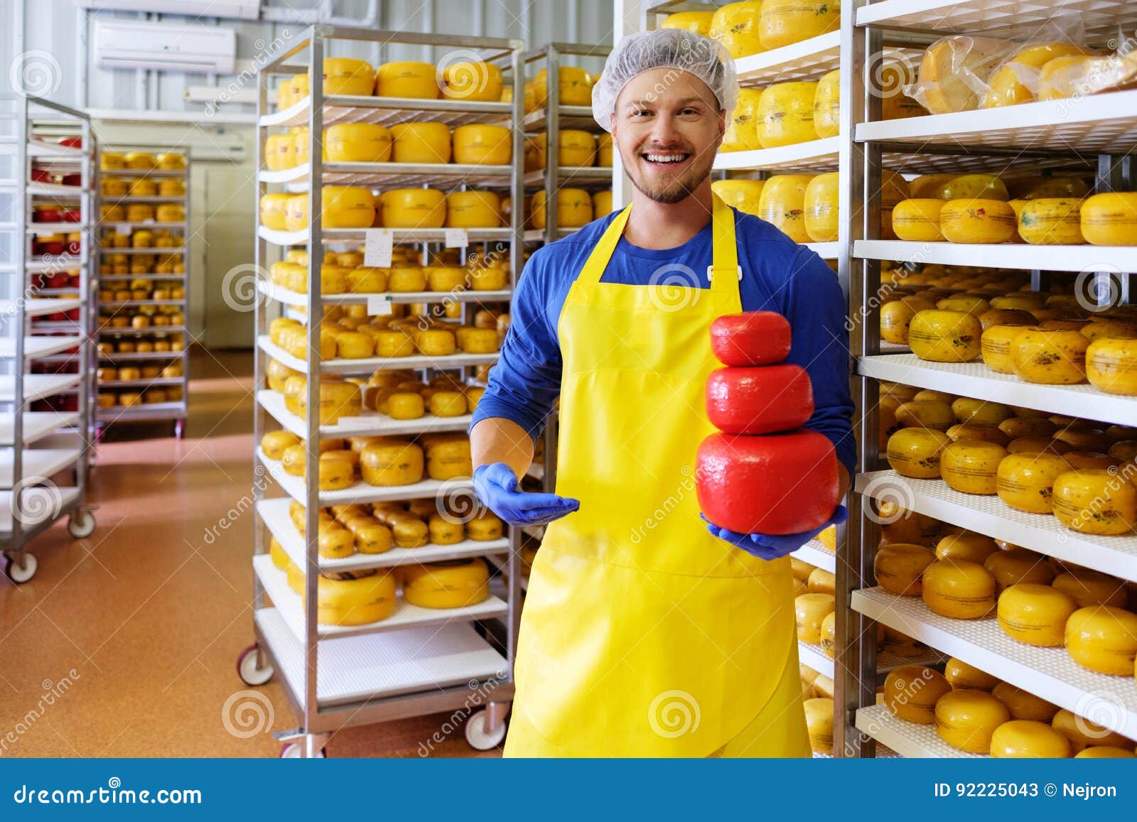 Handsome Cheesemaker is Checking Cheeses in His Workshop Storage. Stock ...