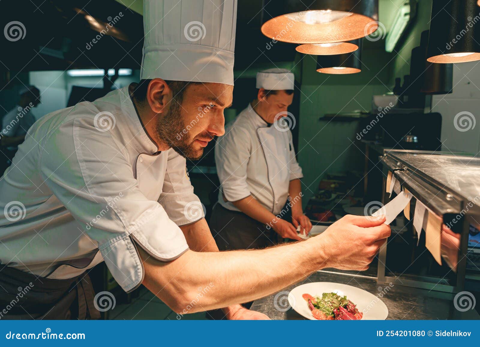 Handsome Chef Cook in Uniform Checking the Order at the Restaurant ...