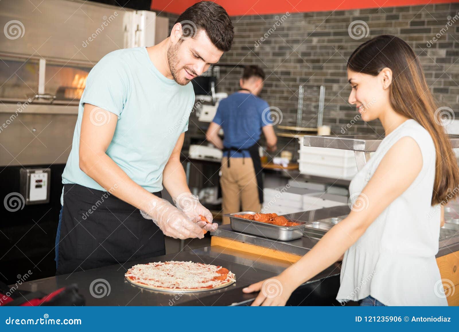 Handsome Chef Cooking Pepperoni Pizza and Adding Ingredients on Stock ...