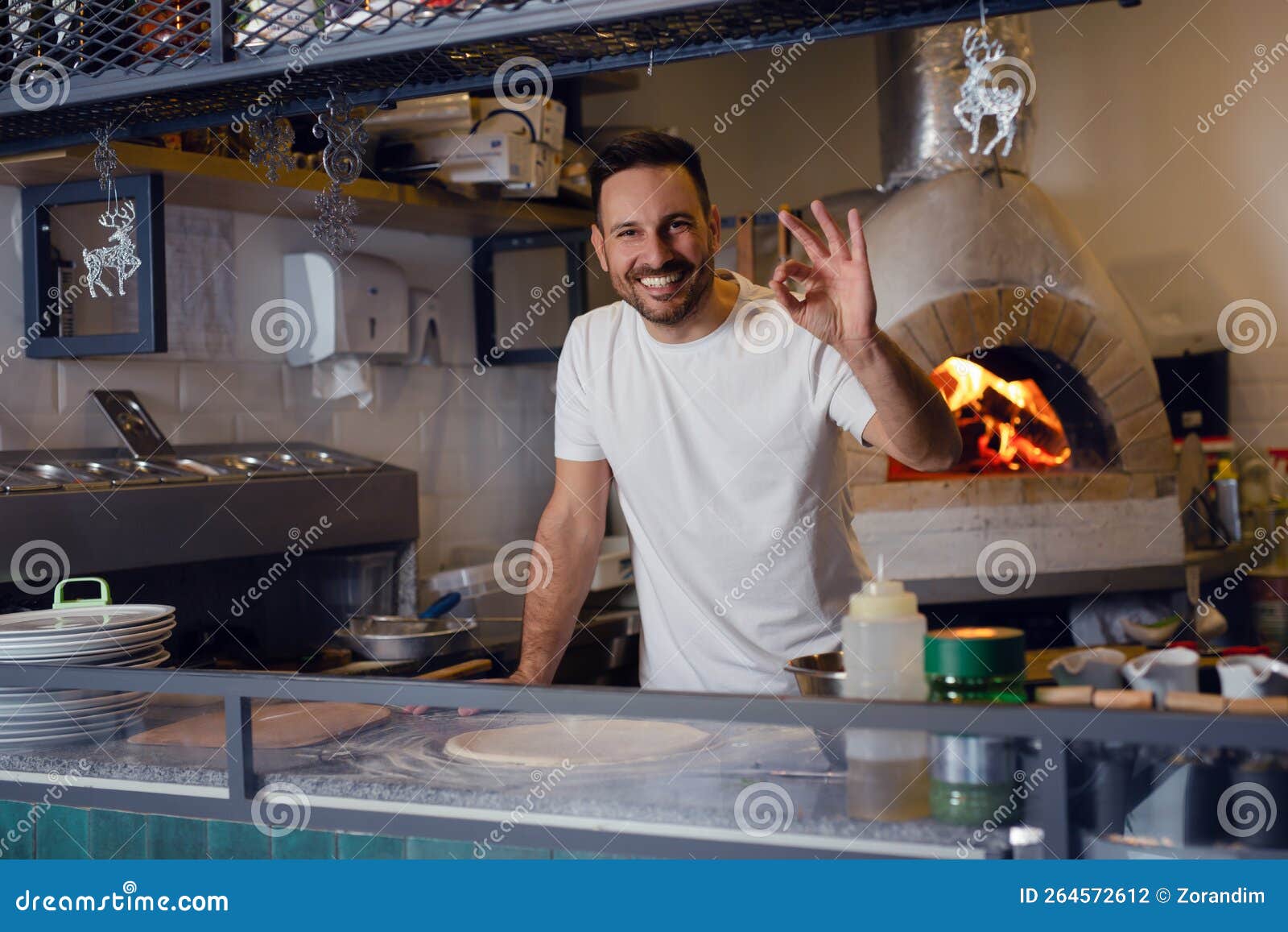 Handsome Chef Presenting Pizza in a Commercial Kitchen Stock Photo ...