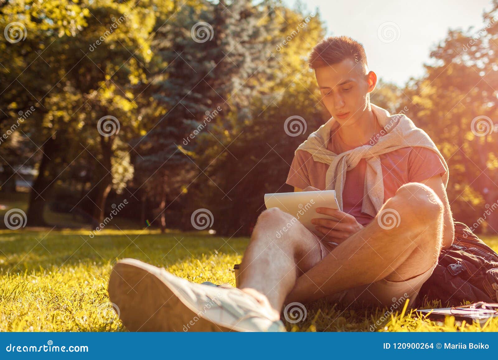 Handsome College Man Writing Notes in Copybook in Campus Park. Happy ...