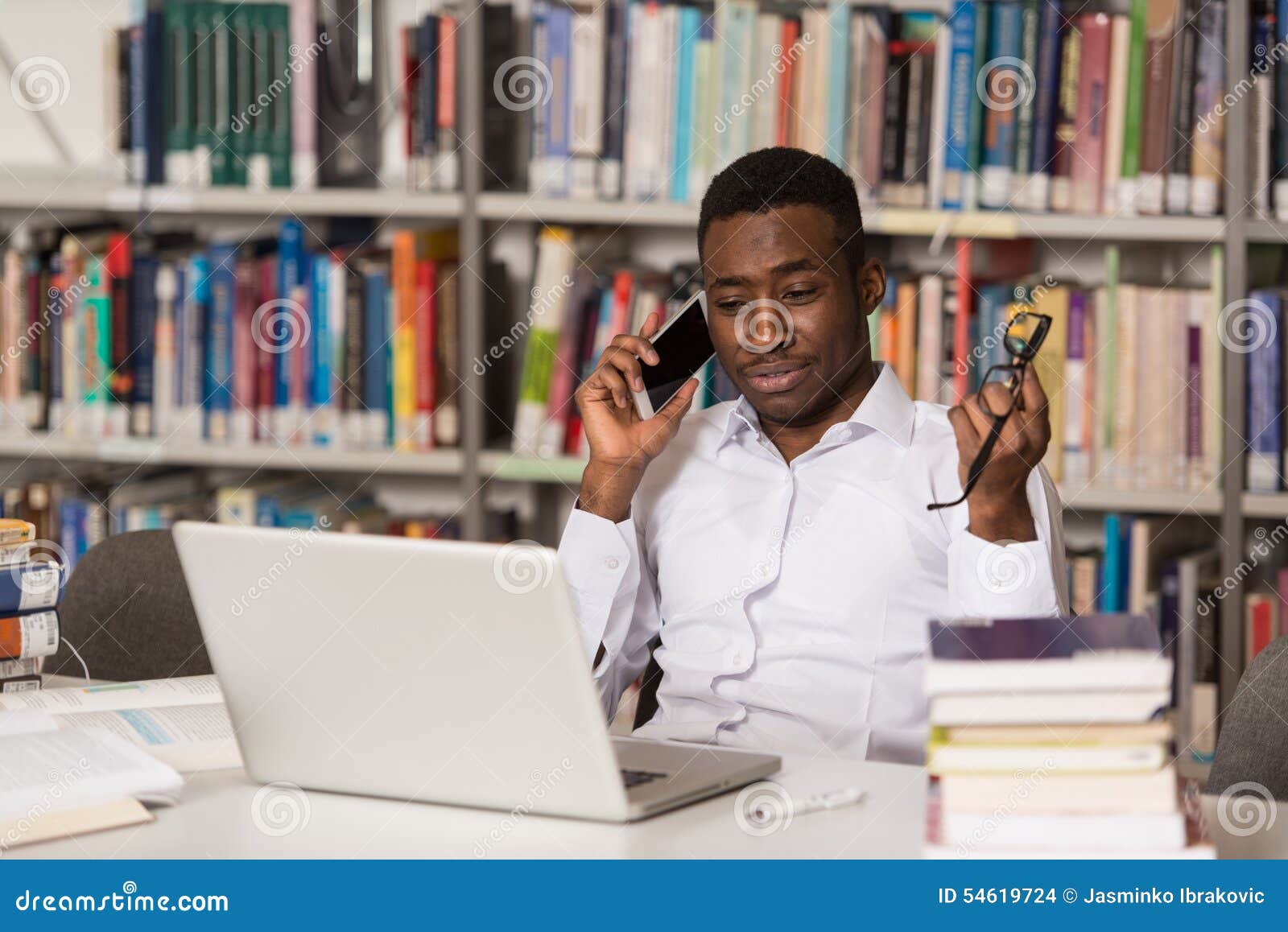 Handsome College Student Using Mobile Phone in Library Stock Photo ...