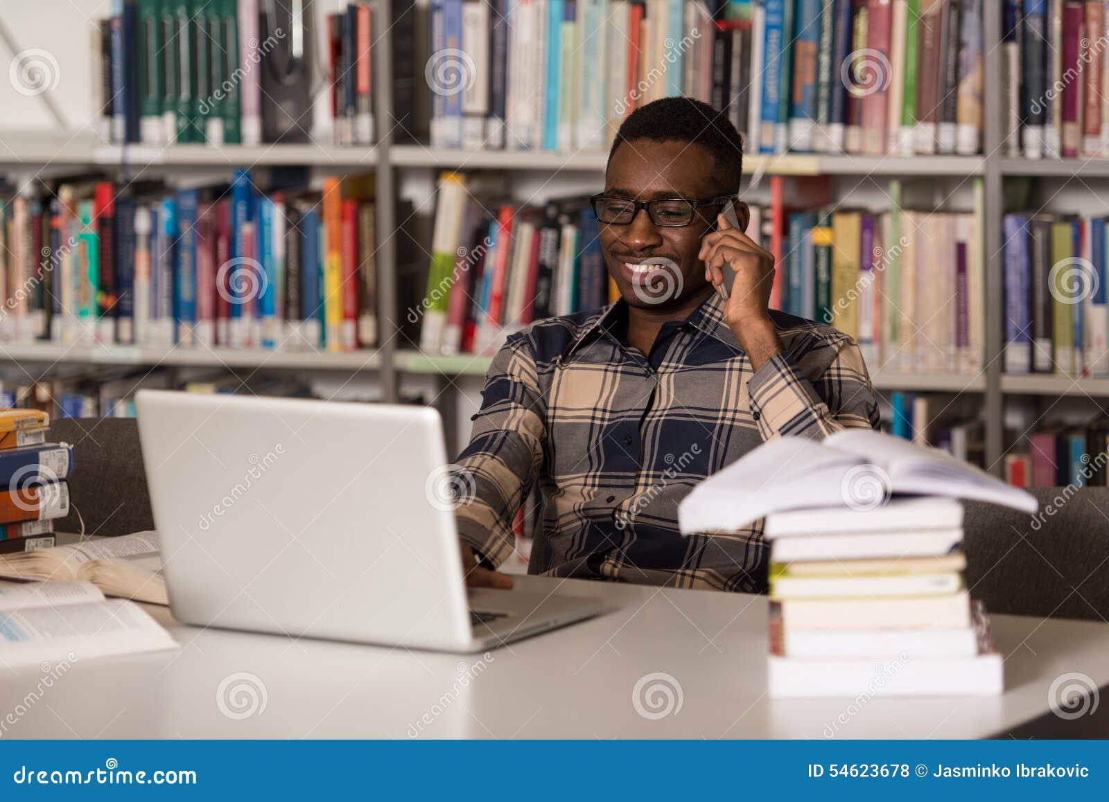 Handsome College Student Using Mobile Phone in Library Stock Photo ...