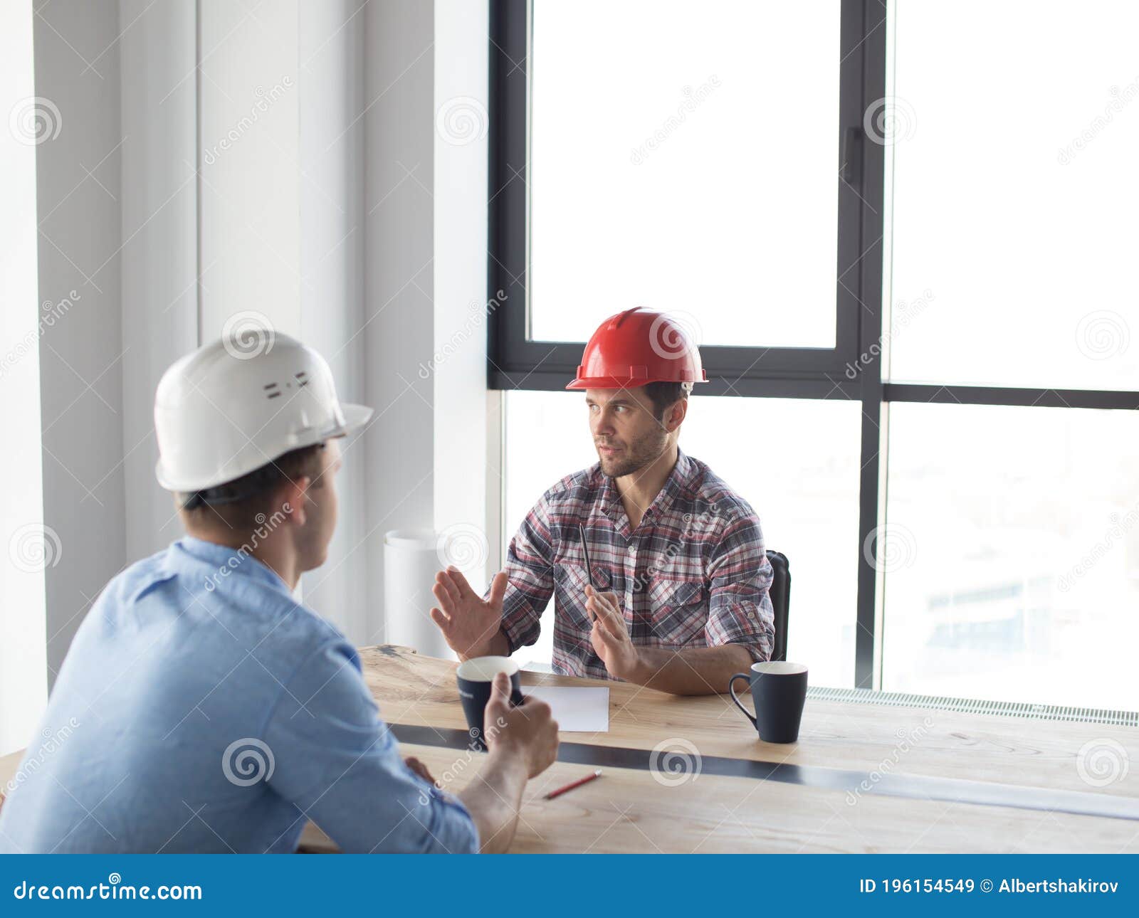 Handsome Construction Worker is Asking His Co-worker To Calm Down Stock ...