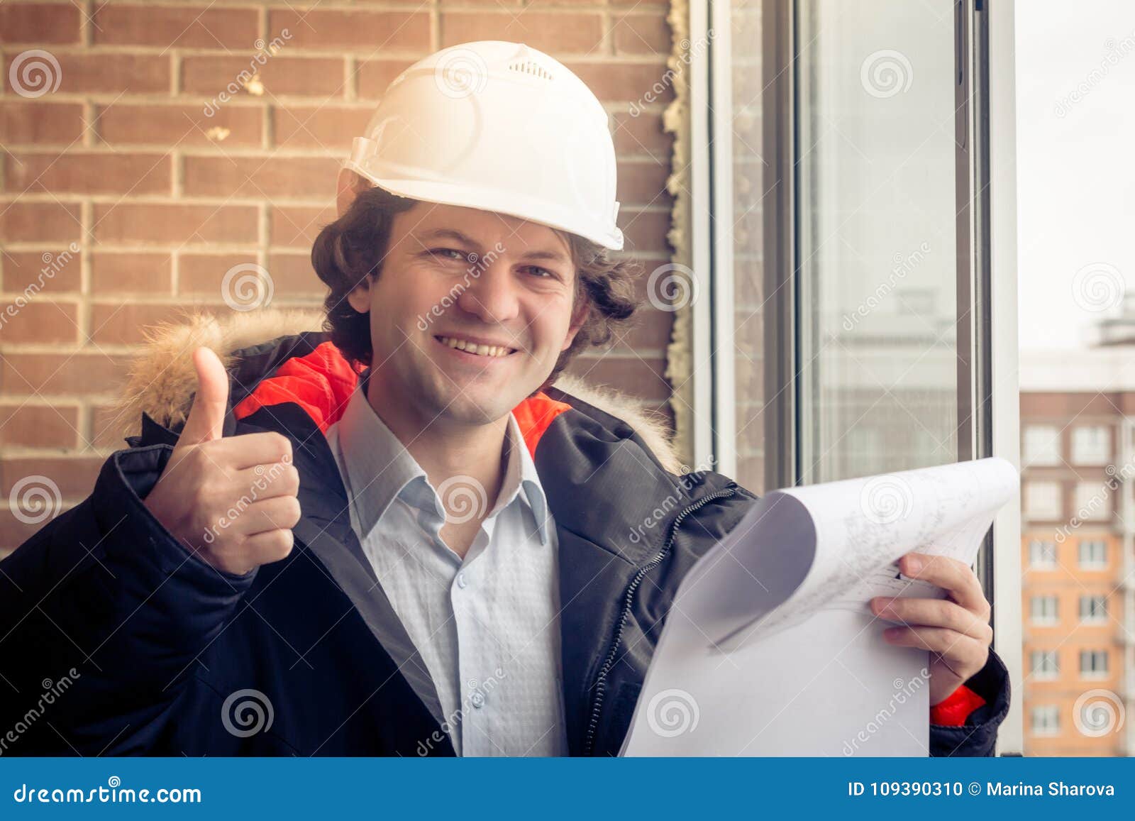 A Handsome Construction Worker Giving a Thumbs-up Sign. Authentic ...
