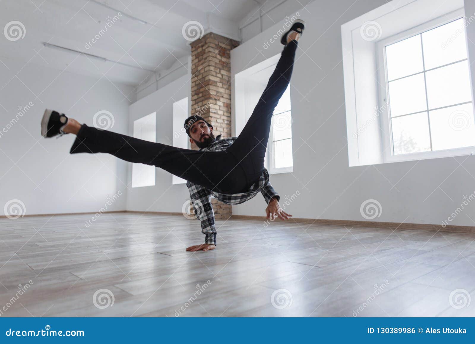 Handsome Dancer Man with a Cap Dances in Motion in the Hall. Stock ...