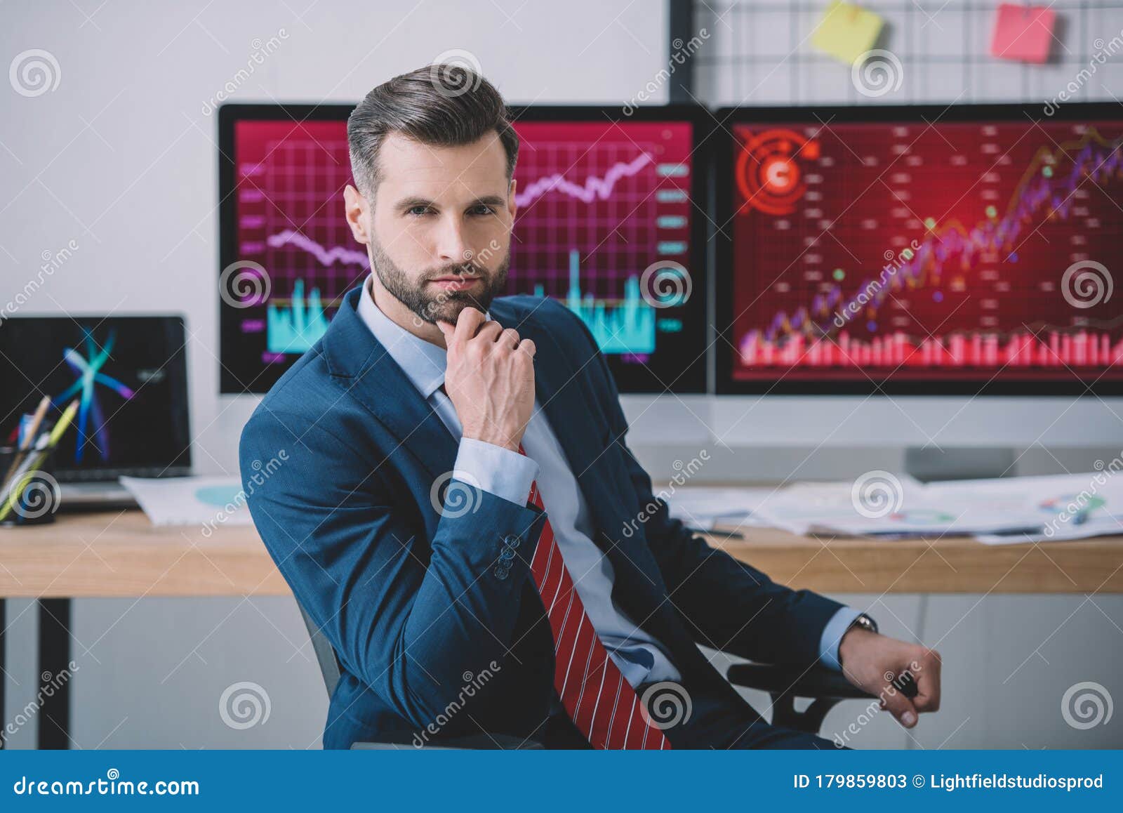 Handsome Data Analyst Looking at Camera Near Charts on Computer ...