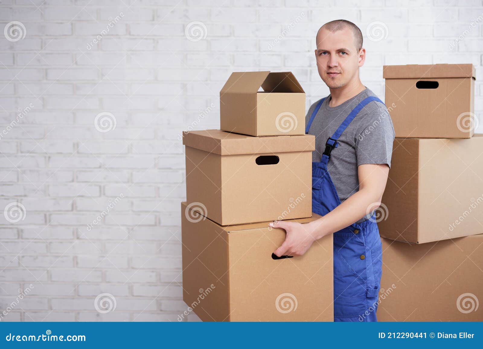 Handsome Man Loader Holding Many Boxes – Copy Space Over White Brick ...