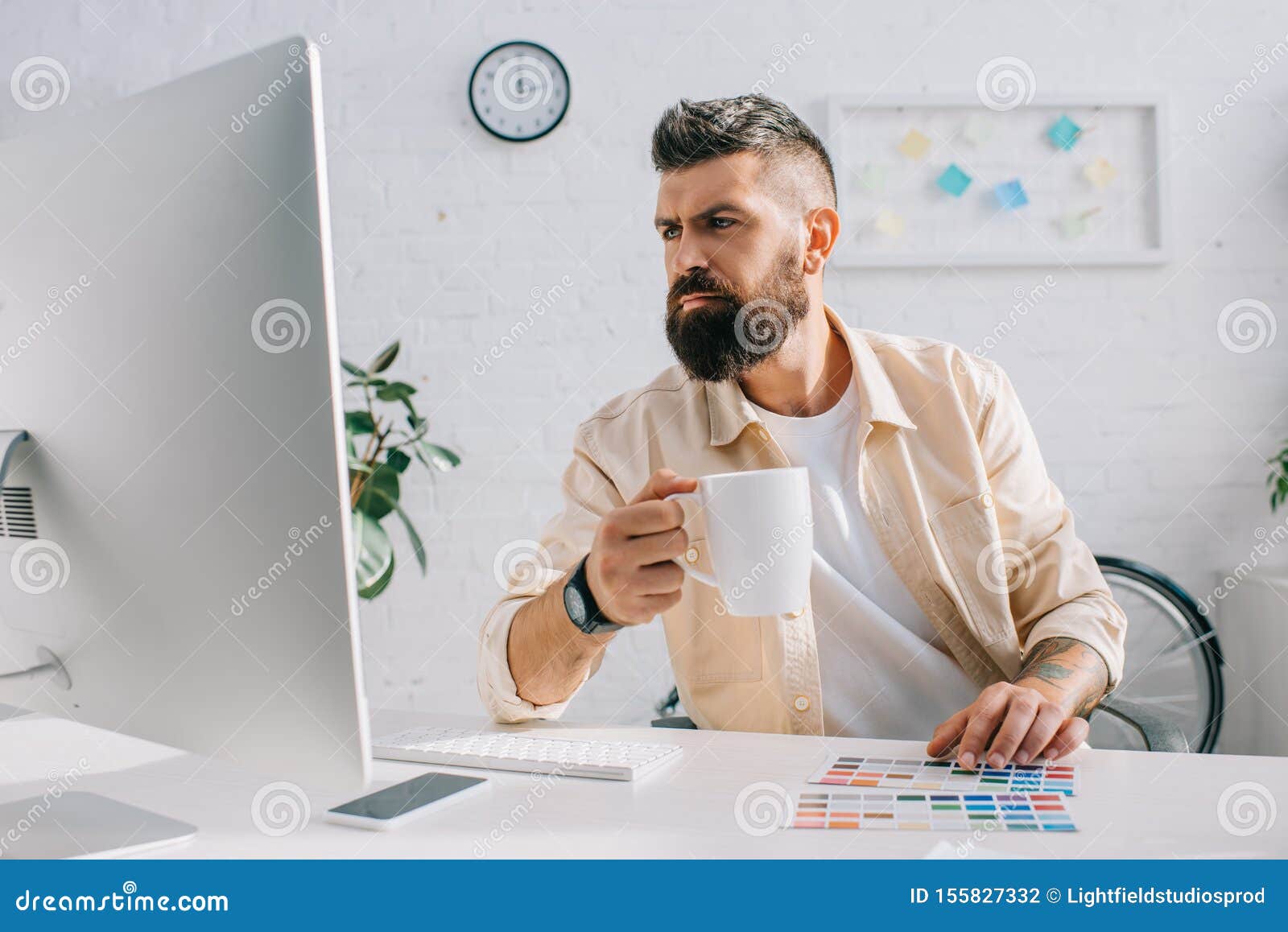 Handsome Designer Drinking Beverage and Looking at Computer Monitor ...