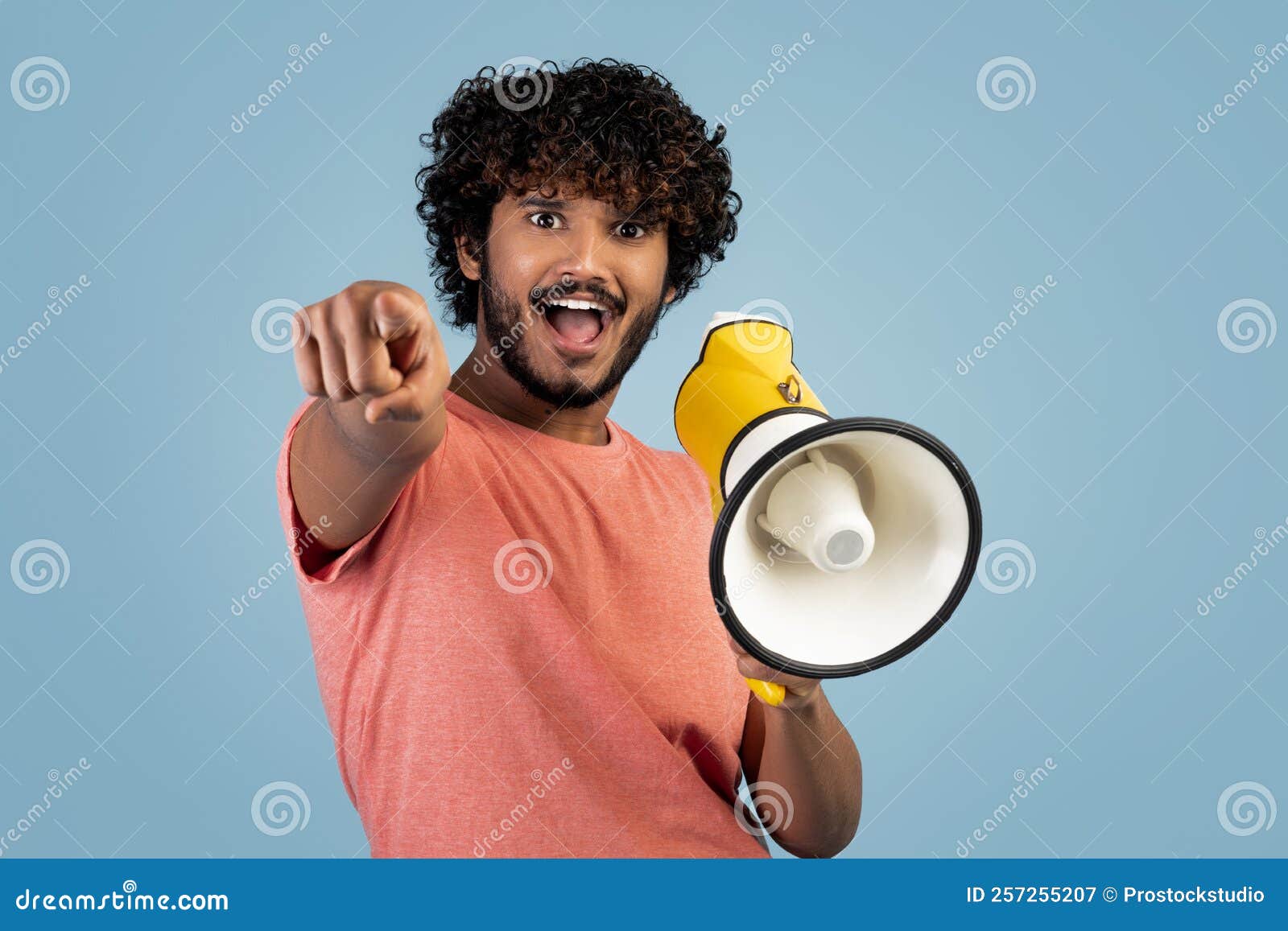 Handsome Eastern Guy Shouting through Loudspeaker and Gesturing Stock ...