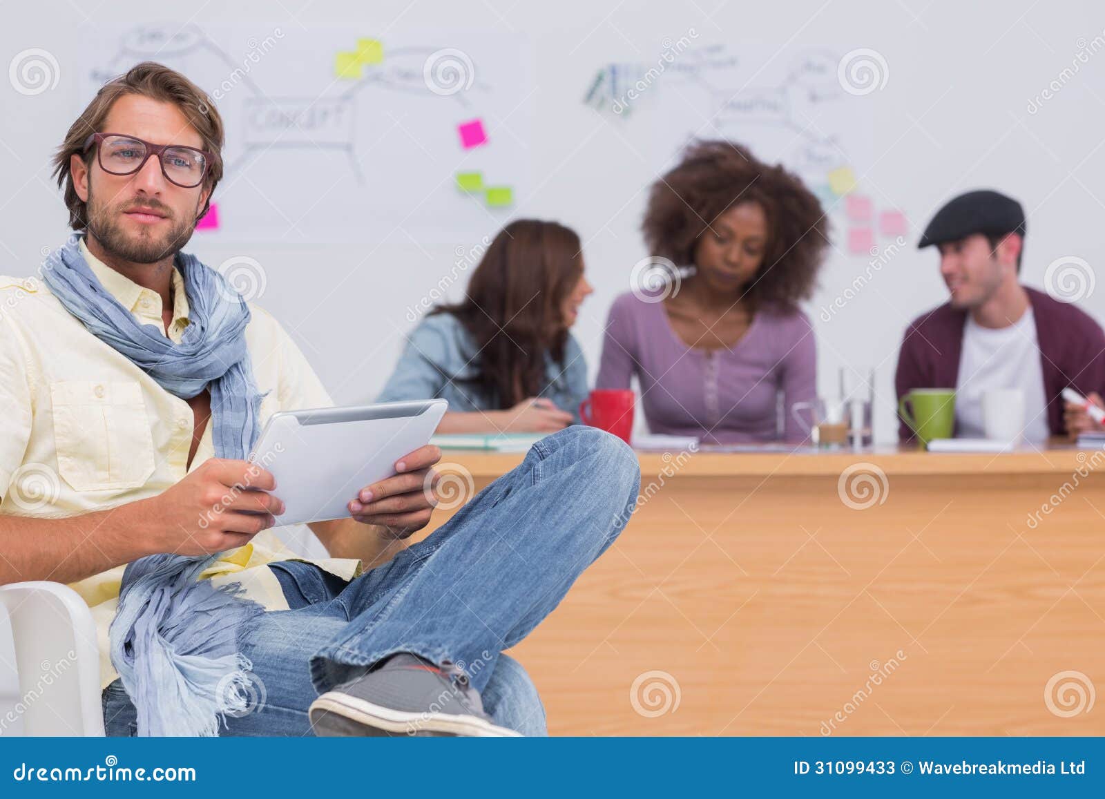 Happy Editor Using Tablet As Team Works Behind Him Stock Photos - Free ...