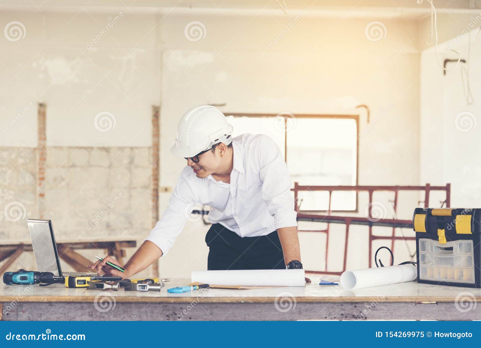 Handsome Engineer Working in Construction Site. Construction Concept ...