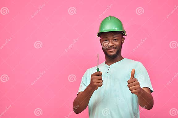 Handsome Excited Young Black Man Wearing A Hard Hat And Holding A