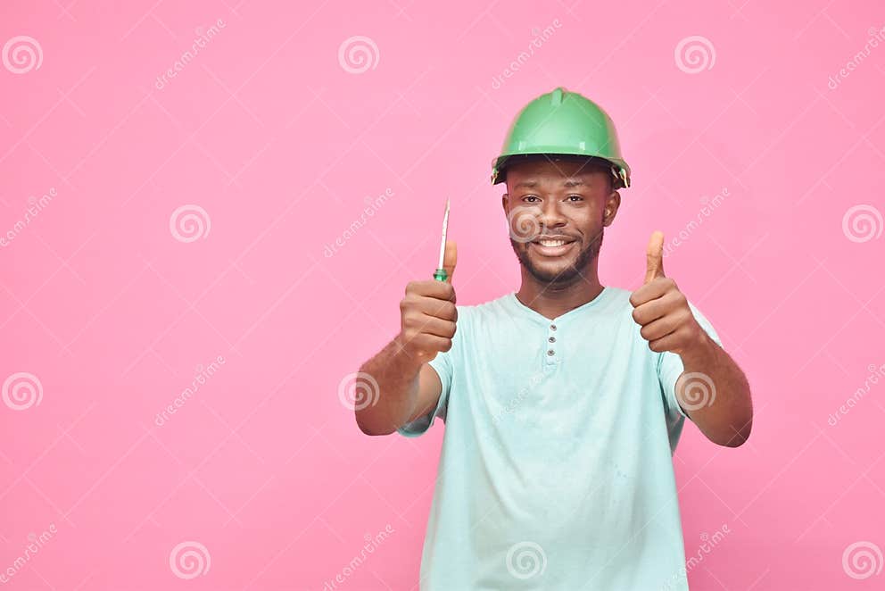 Handsome Excited Young Black Man Wearing A Hard Hat And Holding A
