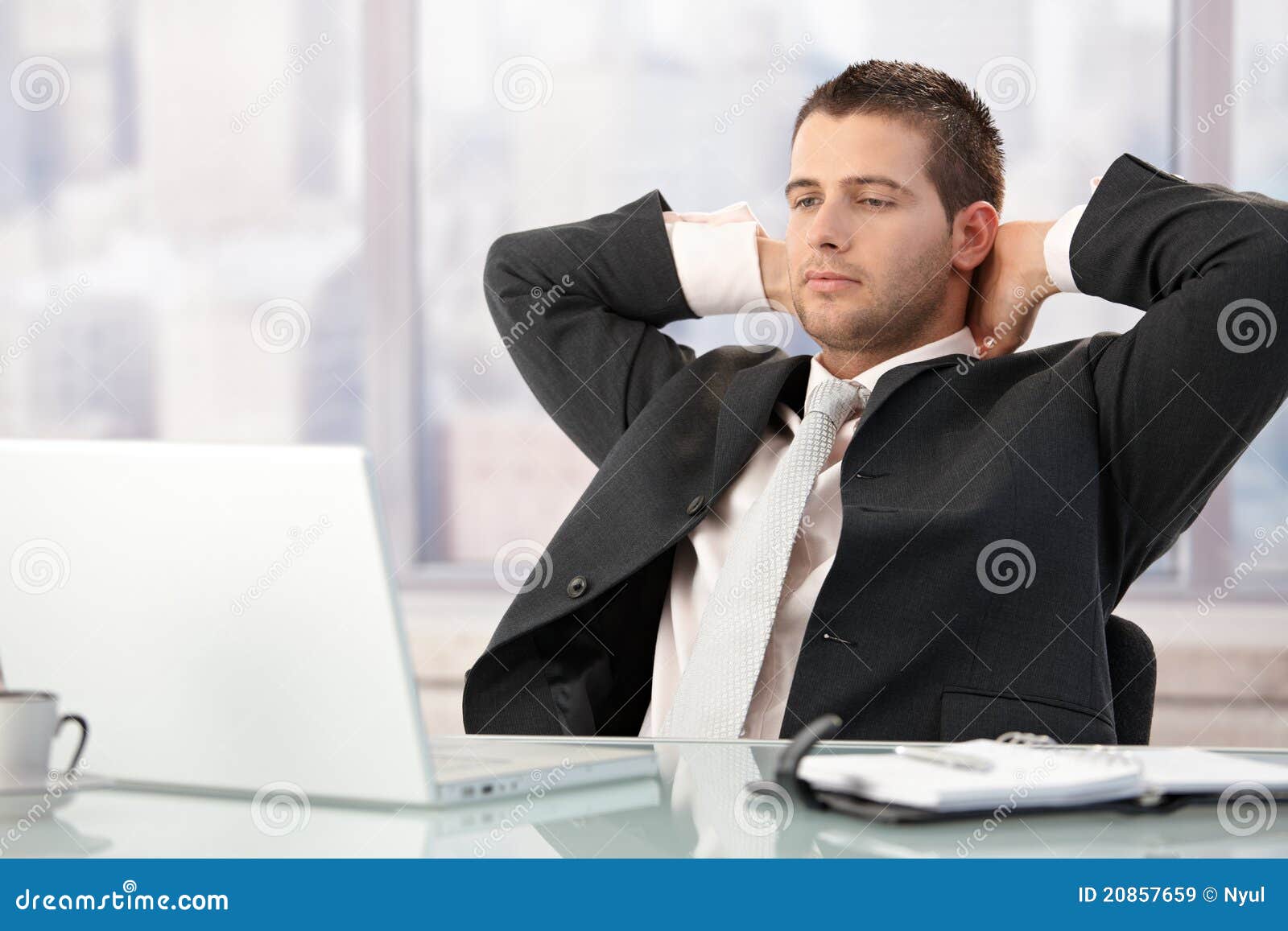 Handsome Executive Sitting at Desk Stretching Stock Image - Image of ...